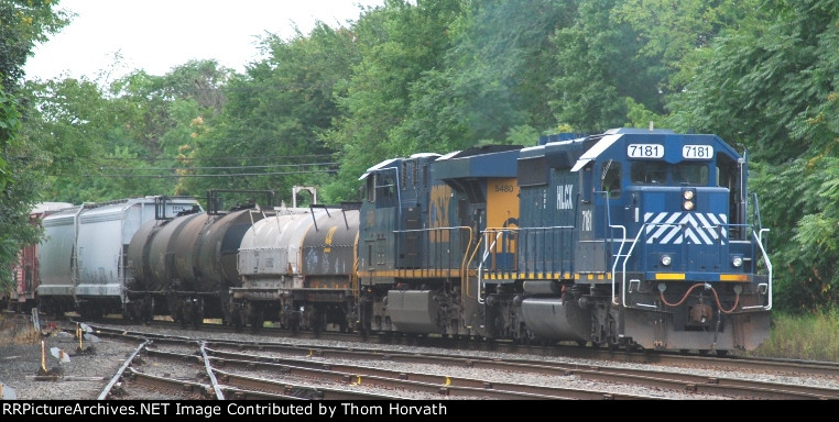HLCX 7181 (ex-BN 7181) is seen passing thru Manville yard